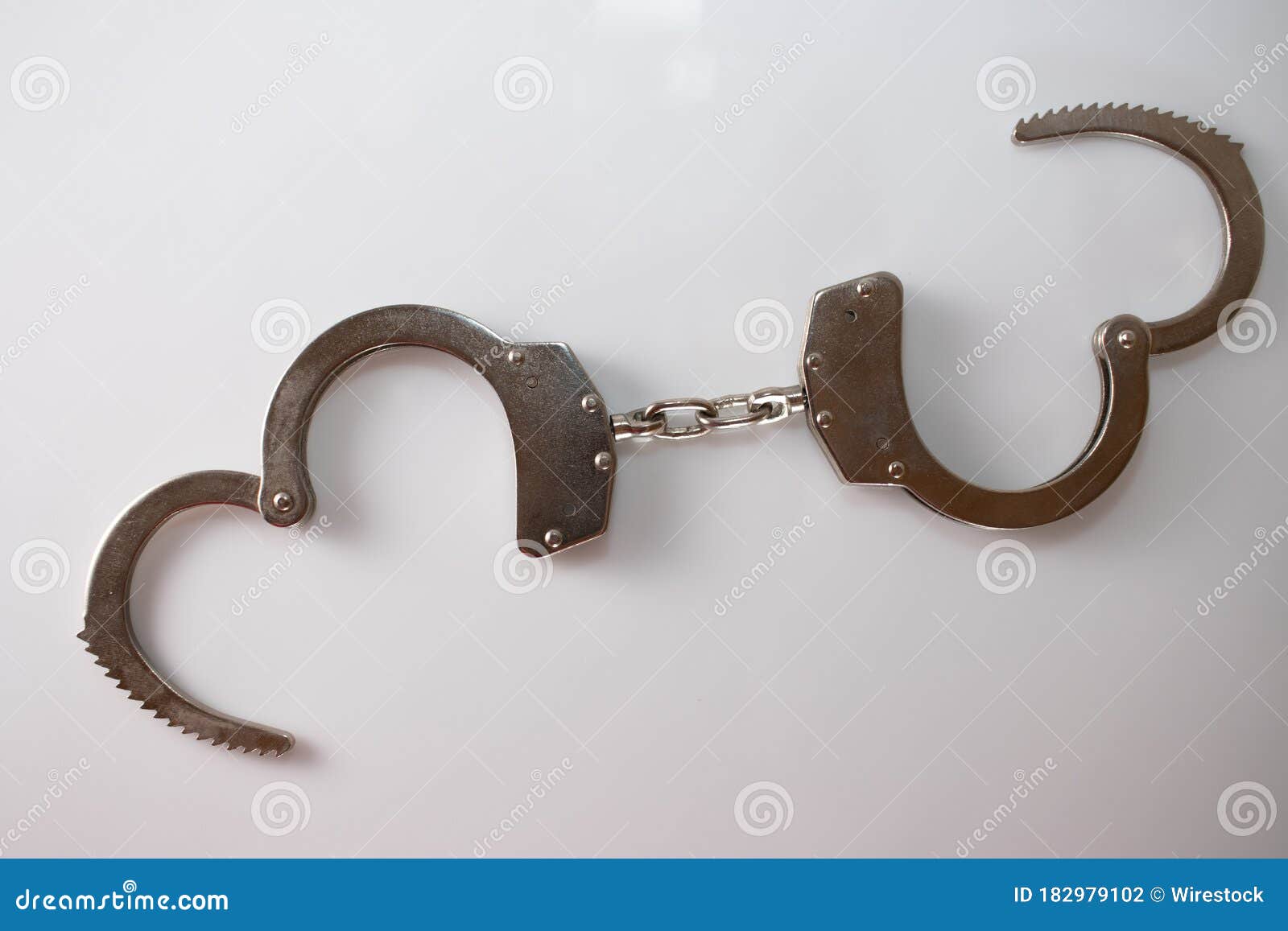 High Angle Shot of Rusted Metal Handcuffs Isolated on a White Surface ...
