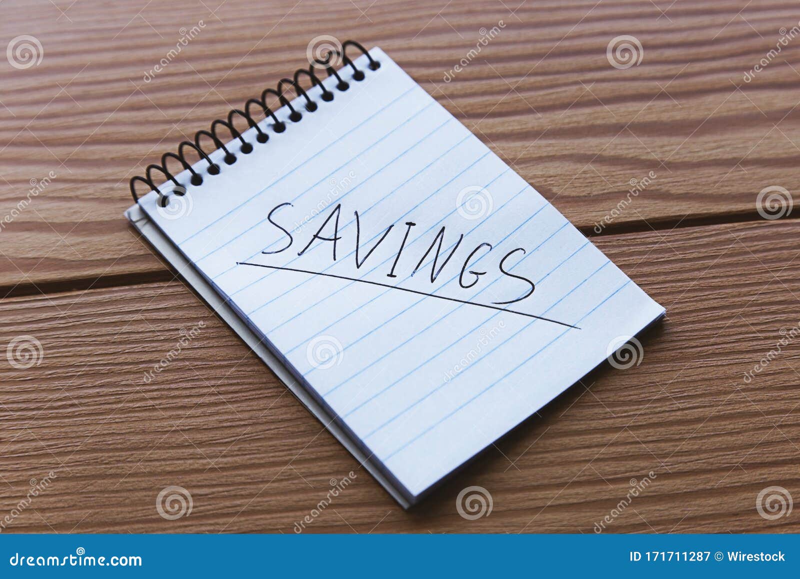 High Angle Shot of a Small Notebook with the Word Savings Written on it ...