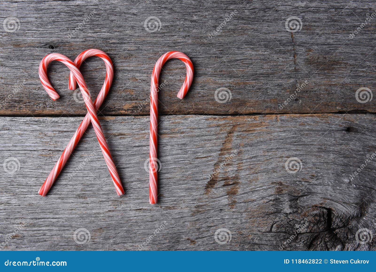 High Angle Shot of Three Holiday Candy Canes on a Rustic Wood Ta Stock ...