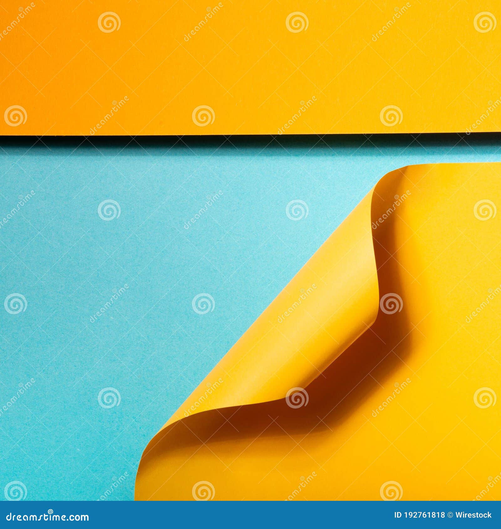 High Angle Shot of a Yellow Half-rolled Paper on a Blue Background ...