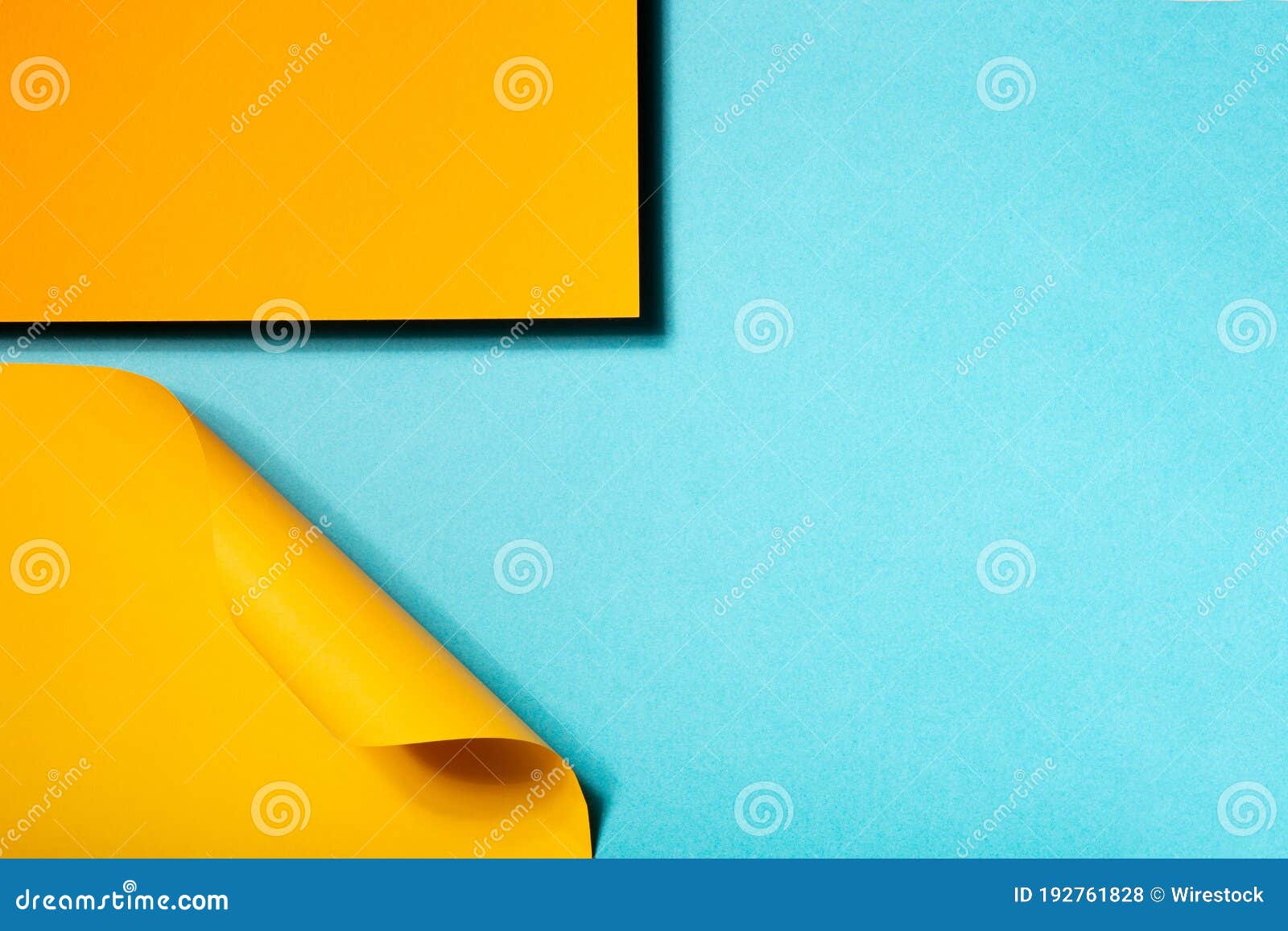 High Angle Shot of a Yellow Half-rolled Paper on a Blue Background ...