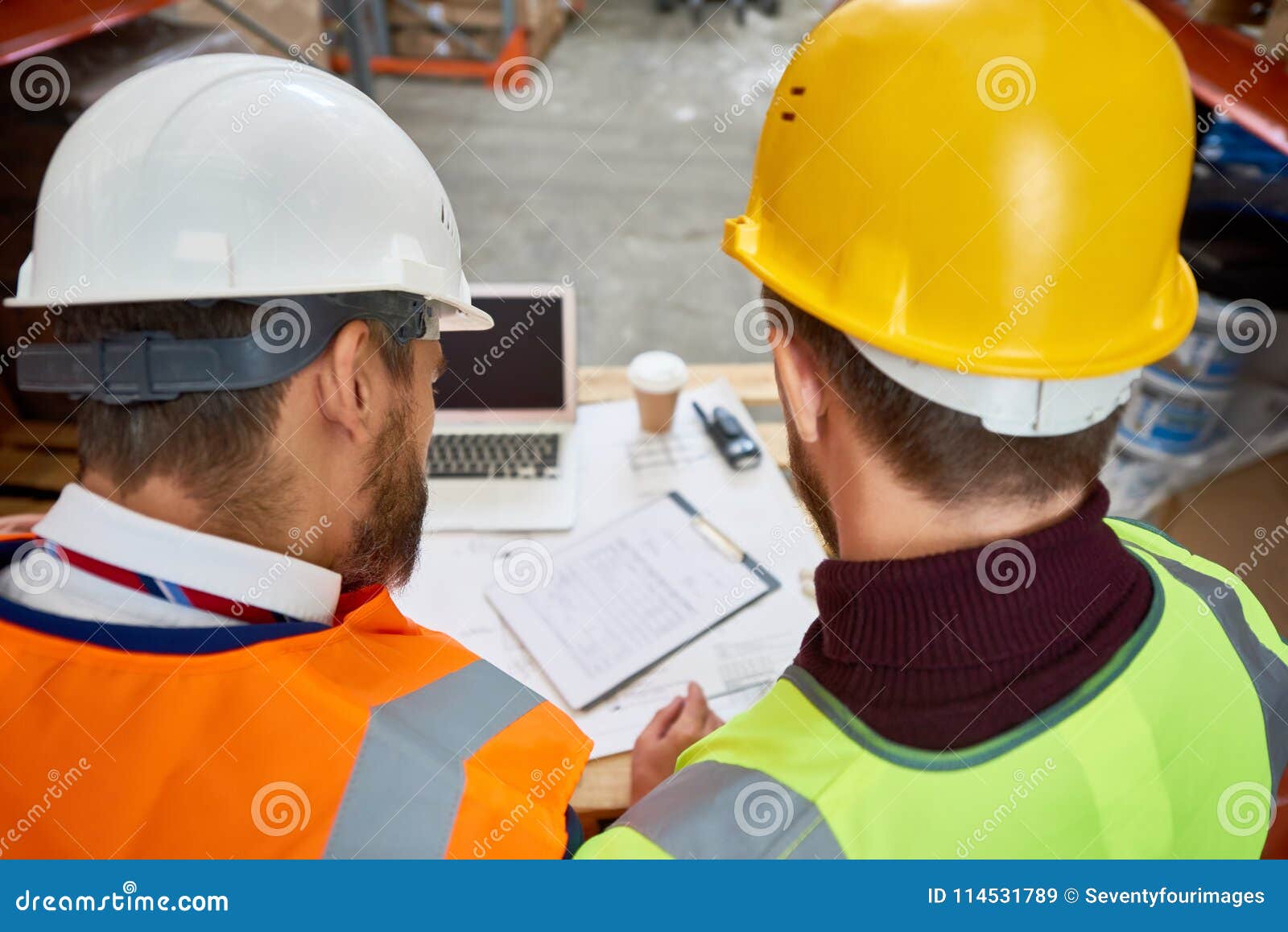Construction Workers Discussing Plans Stock Image - Image of rear ...