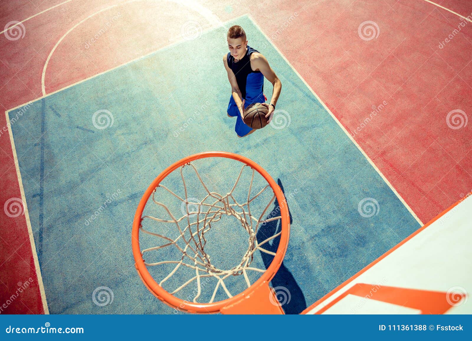 High Angle View of Basketball Player Dunking Basketball in Hoop Stock ...