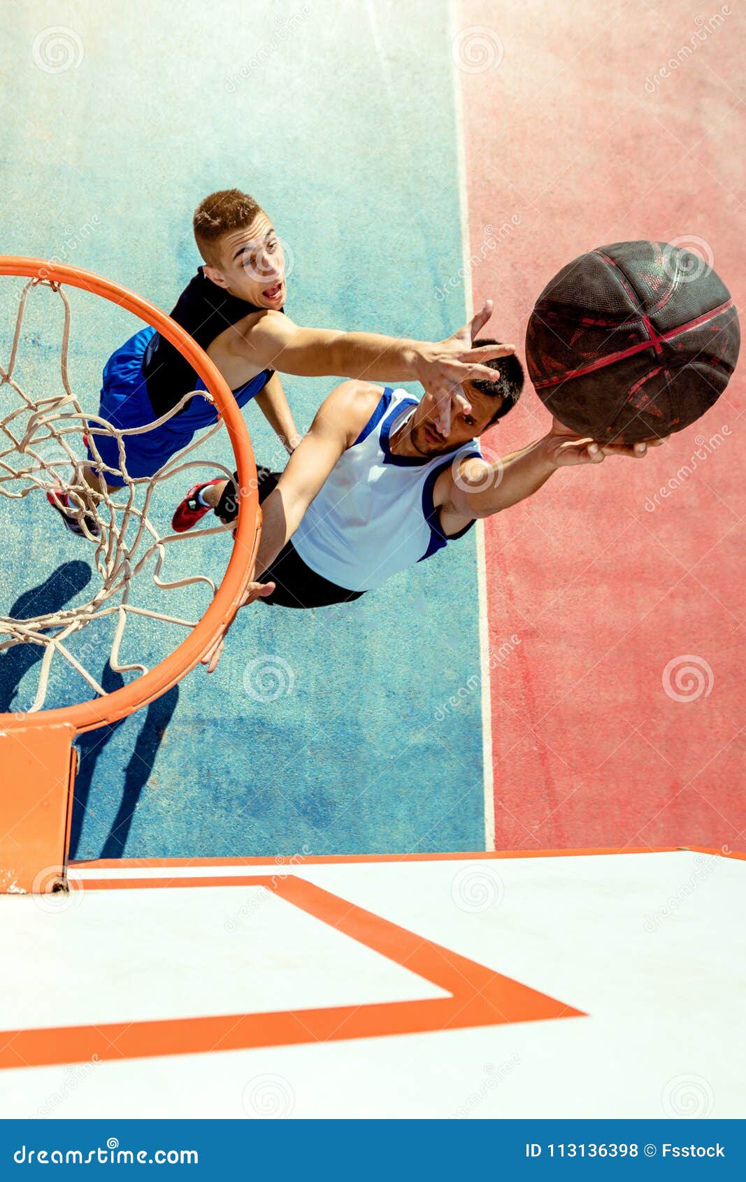 High Angle View of Basketball Player Dunking Basketball in Hoop Stock ...