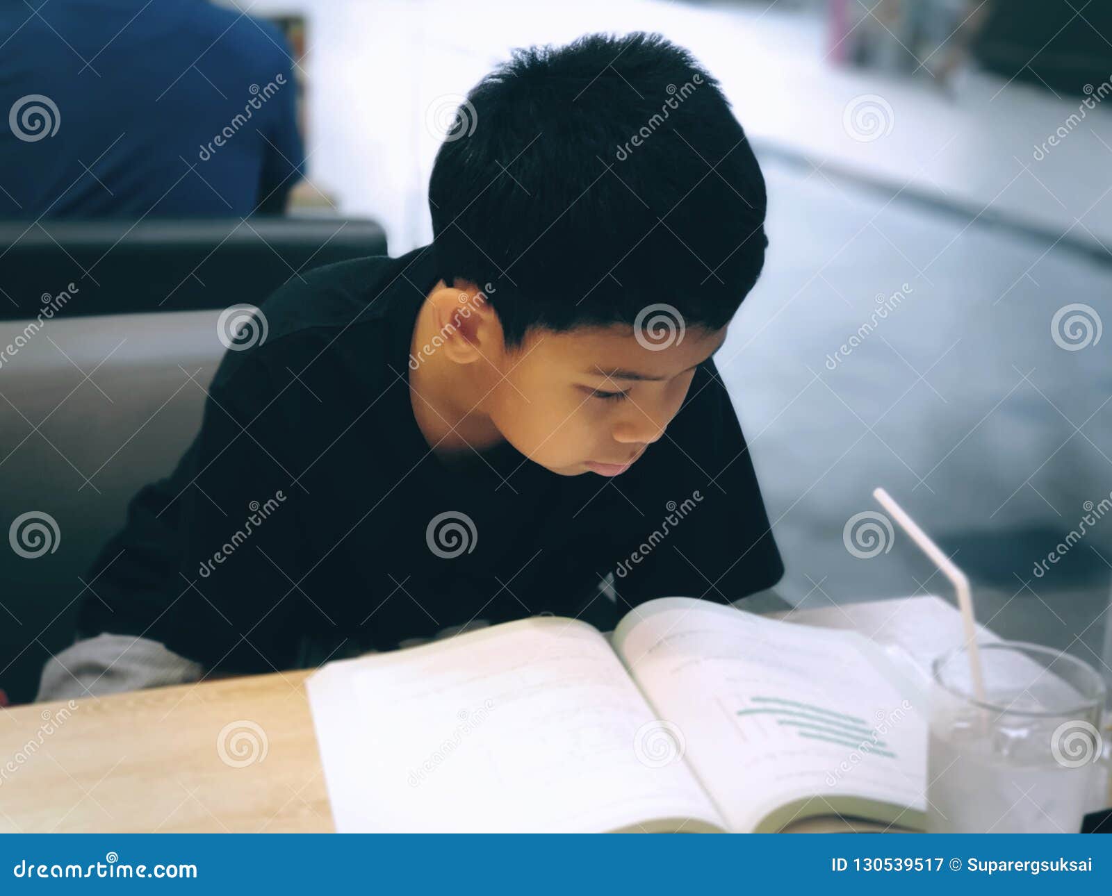 A Boy Reading a Book on the Table Stock Image - Image of table, reading ...