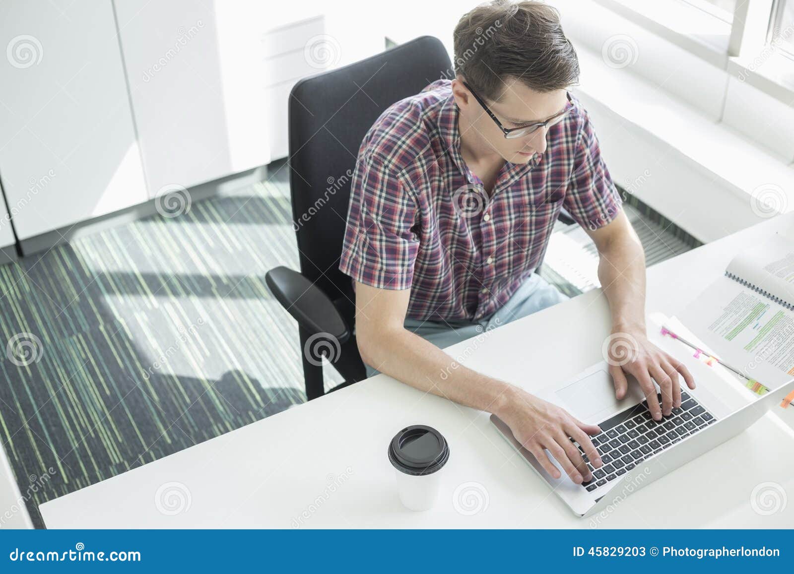High Angle View of Businessman Using Laptop at Desk in Creative Office ...
