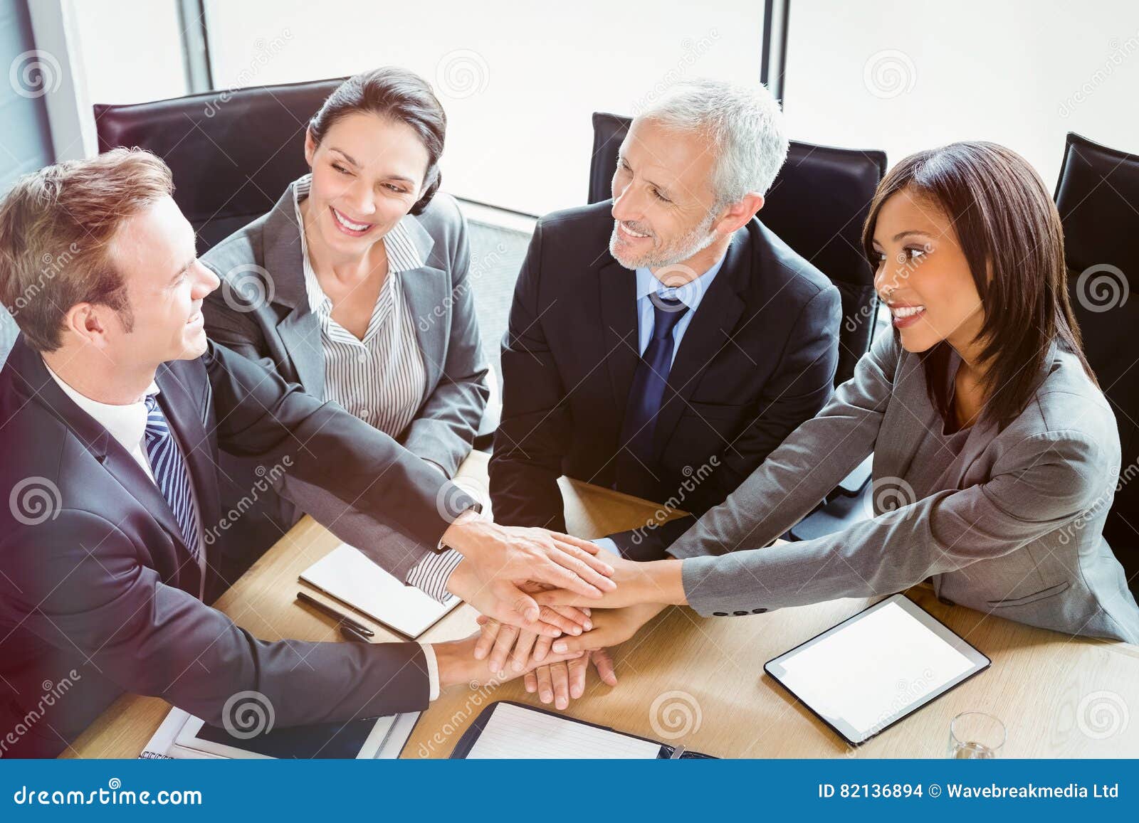 High Angle View of Businesspeople Stacking Hands in Conference Room ...