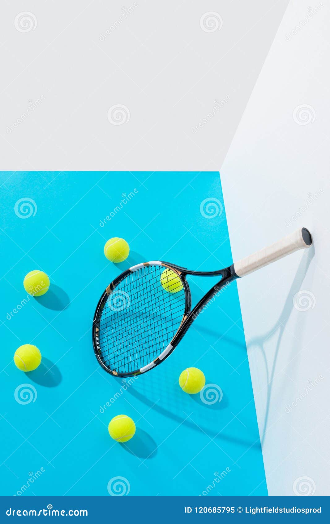 High Angle View Circle of Tennis Balls Around Tennis Racket on Blue ...
