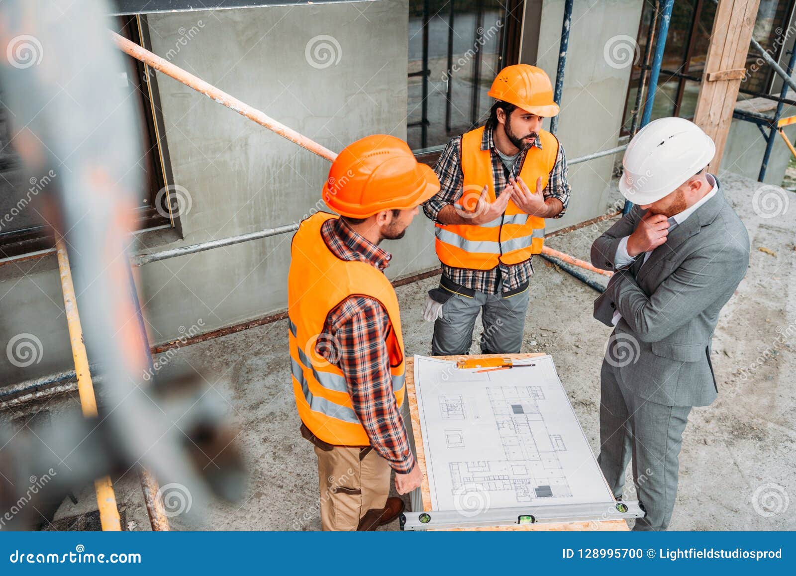 High Angle View of Confused Builders and Architect Discussing Building ...