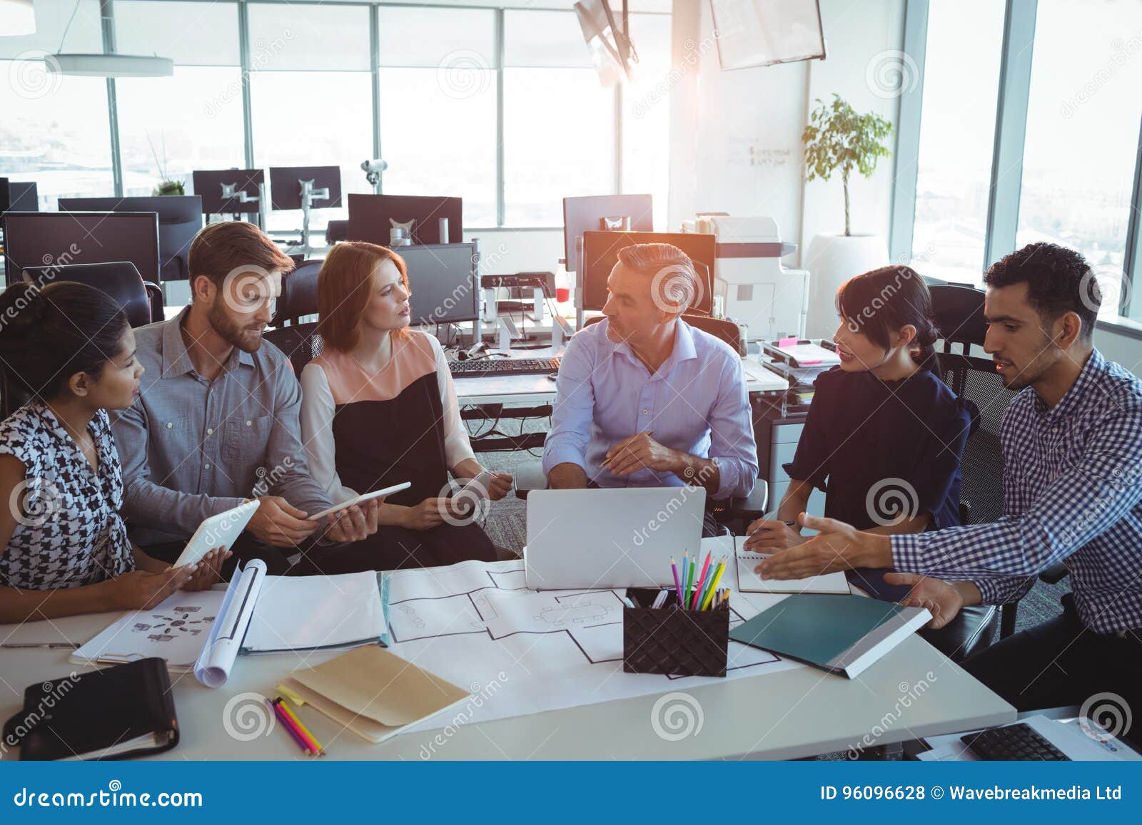 High Angle View of Creative Business Colleagues Discussing Around Desk ...