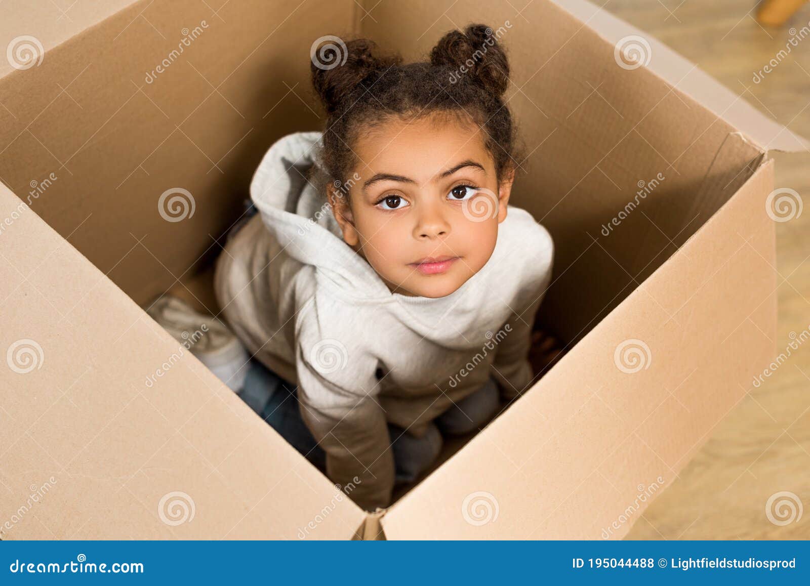 Cute Child Sitting in Box and Looking at Camera Stock Photo - Image of ...