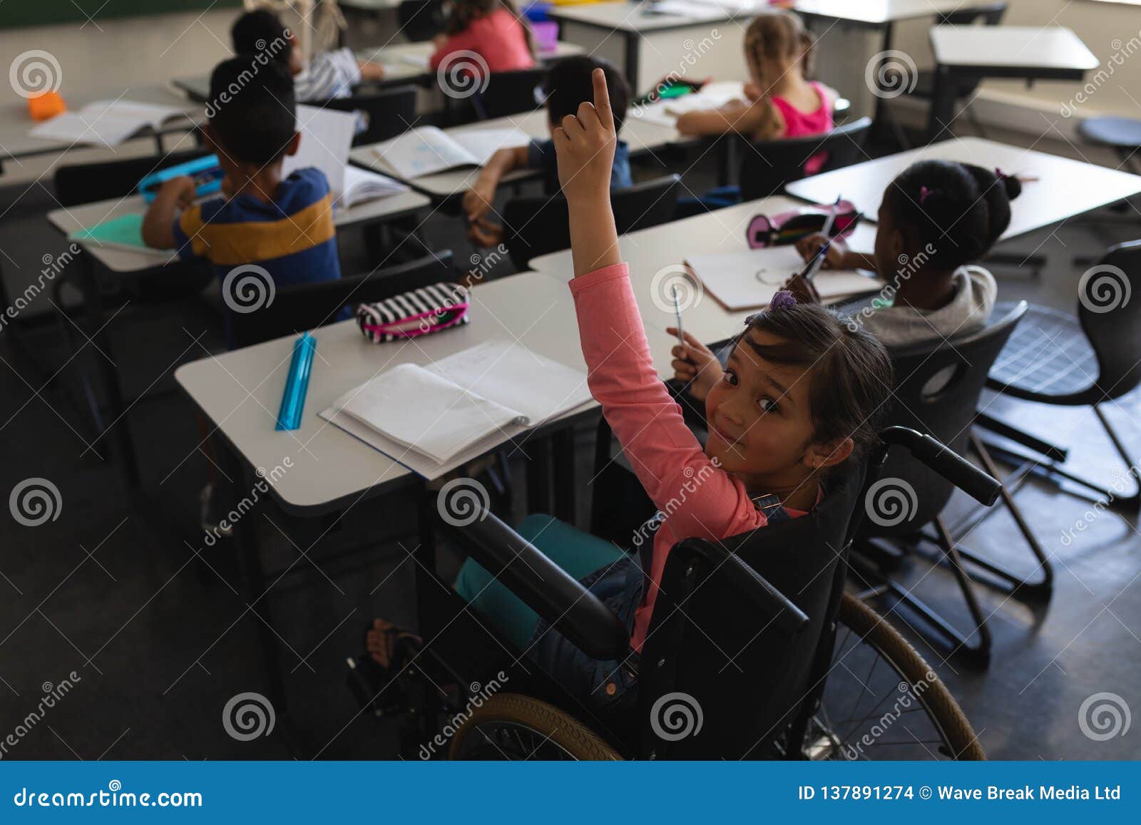 High Angle View of Disable Schoolgirl Looking at Camera and Raising ...
