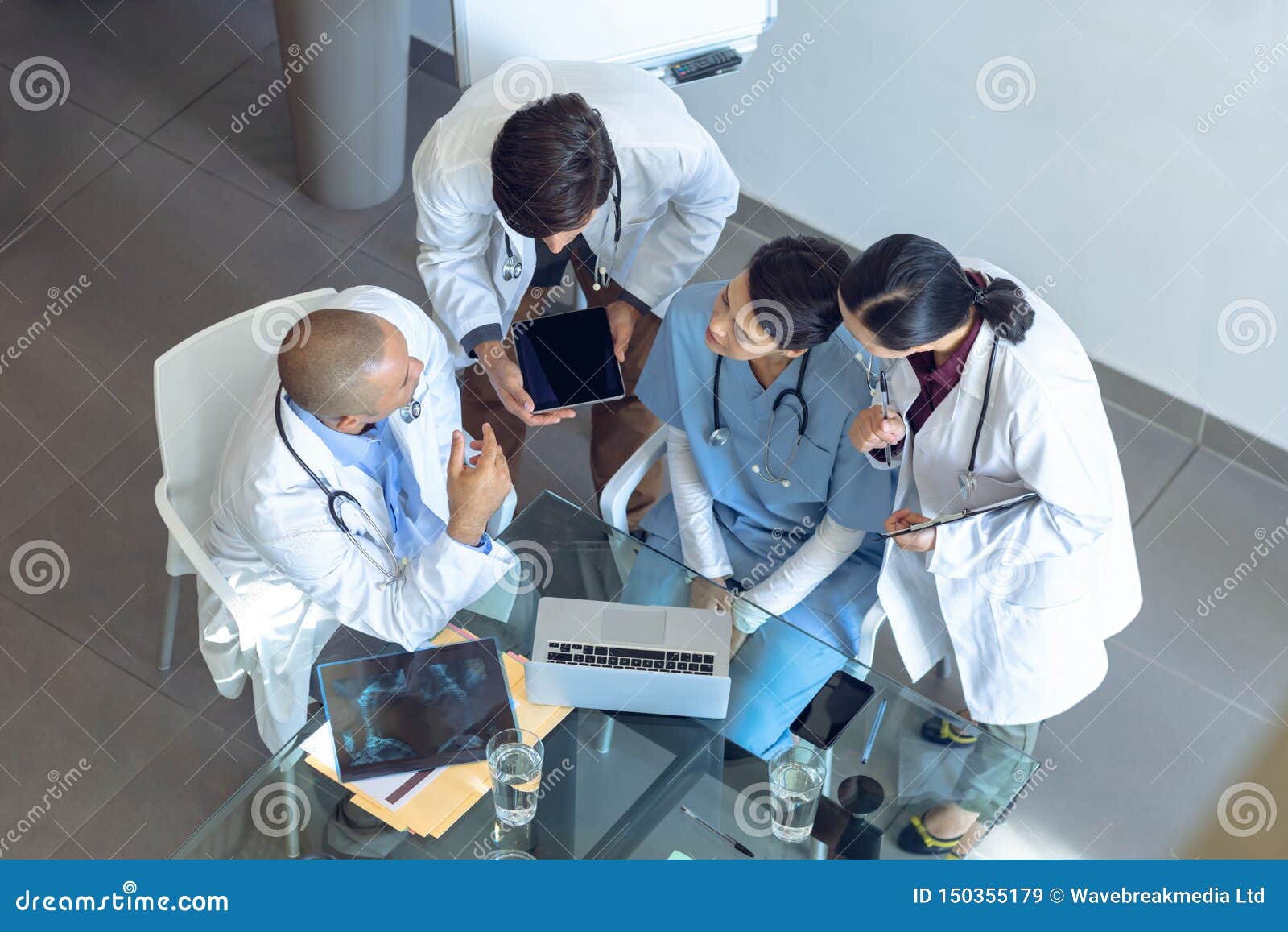 Medical Team Discussing Over Digital Tablet at the Table in Hospital ...