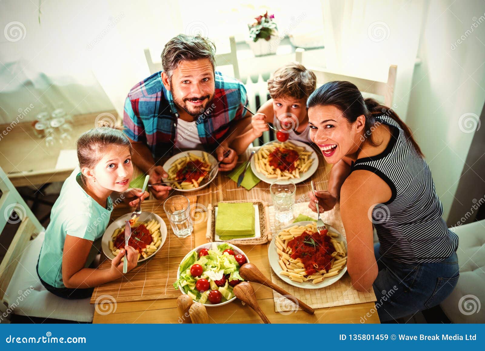 High Angle View of Family Having Meal Together Stock Image - Image of ...