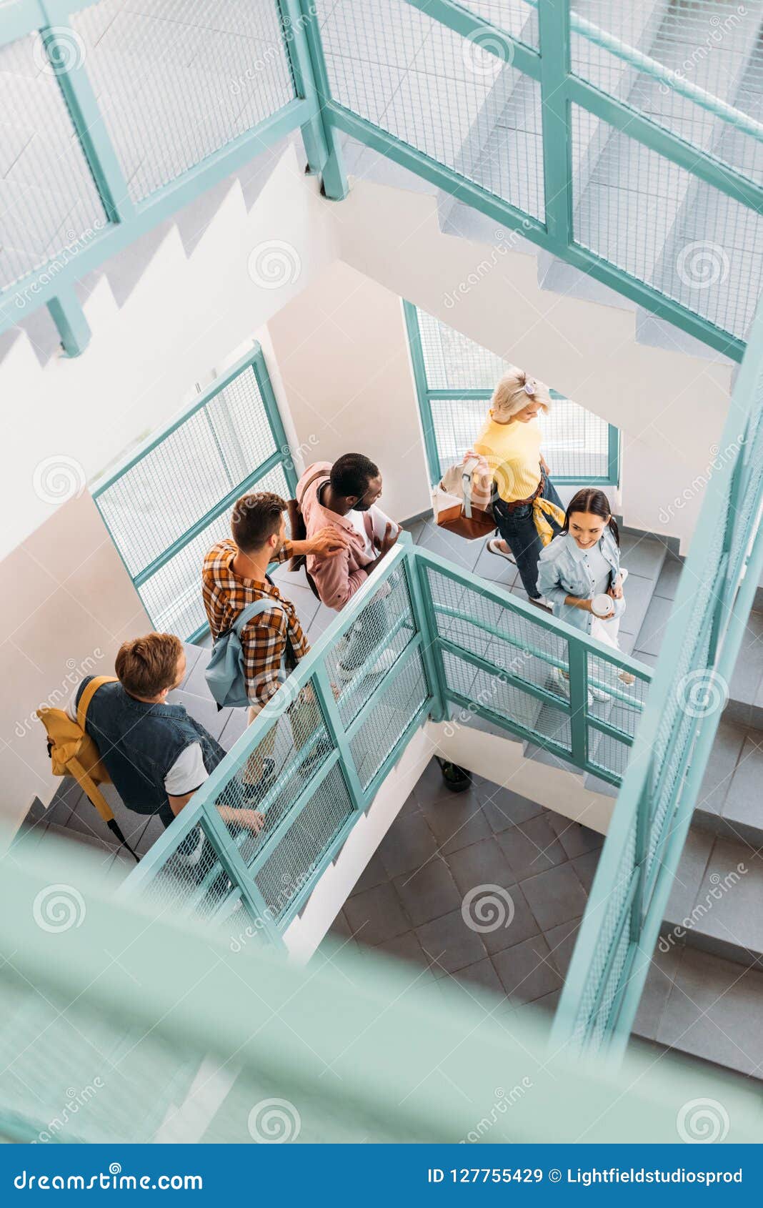 High Angle View of Group of Young Students Walking Down Stairs Stock ...