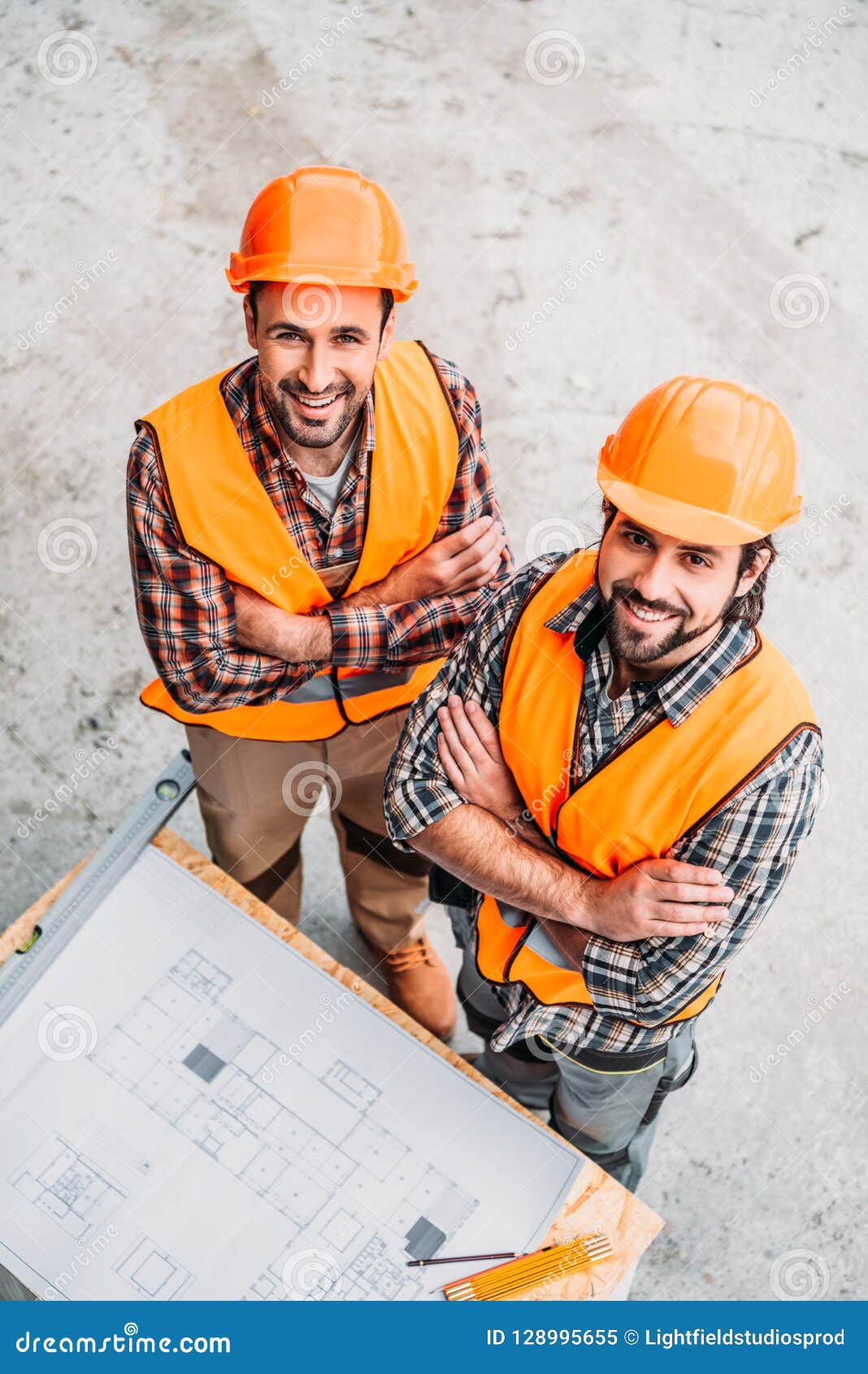 High Angle View of Happy Builders with Blueprint Standing at ...