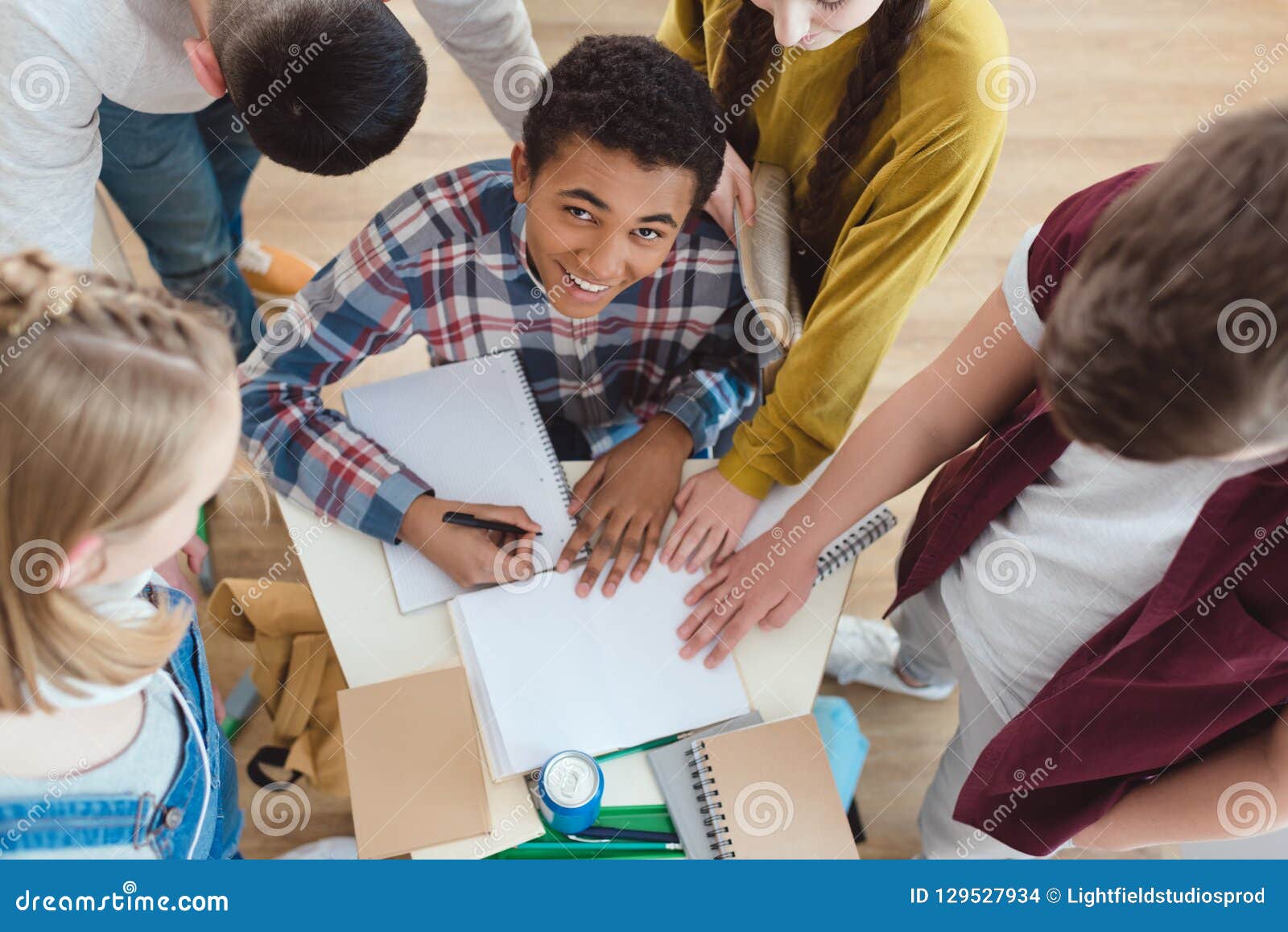 High Angle View of High School Students Helping Their Classmate Stock ...