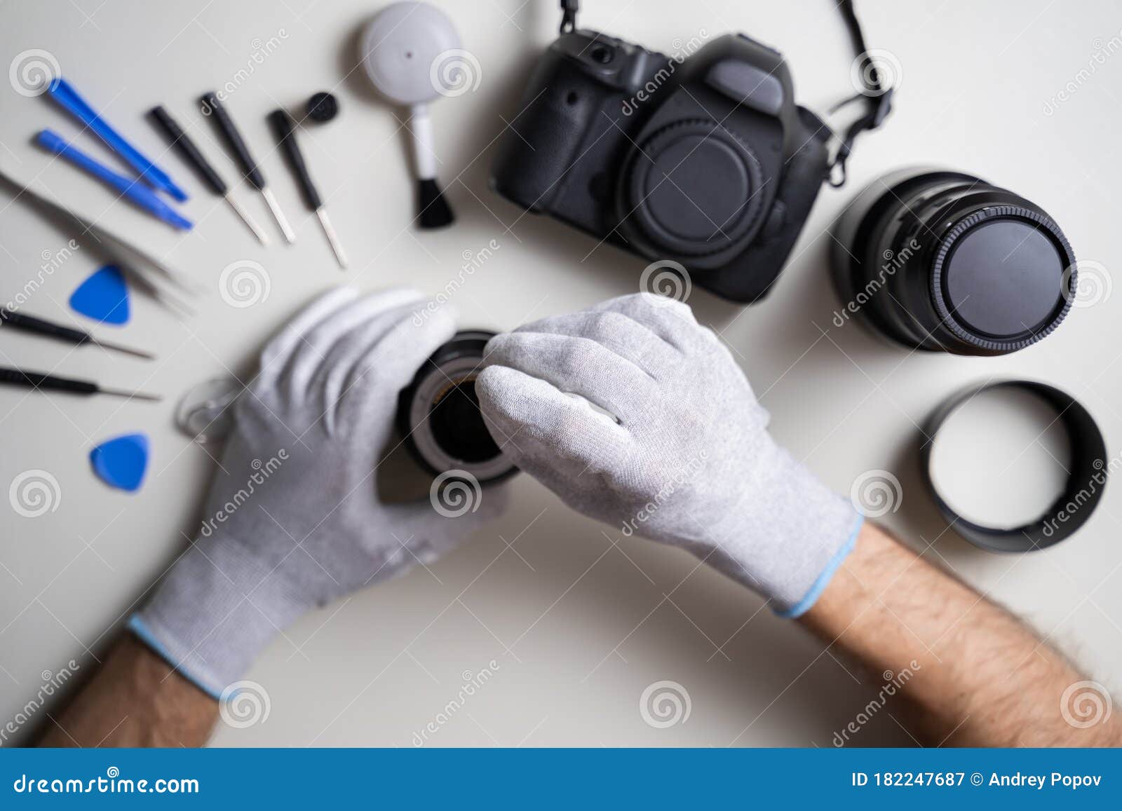 Man Cleaning Camera Lens stock image. Image of care - 182247687