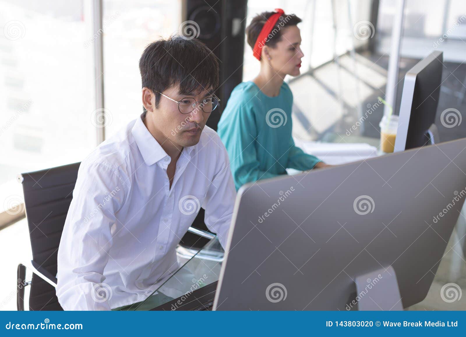 Business People Working on Computer at Desk in Office Stock Photo ...