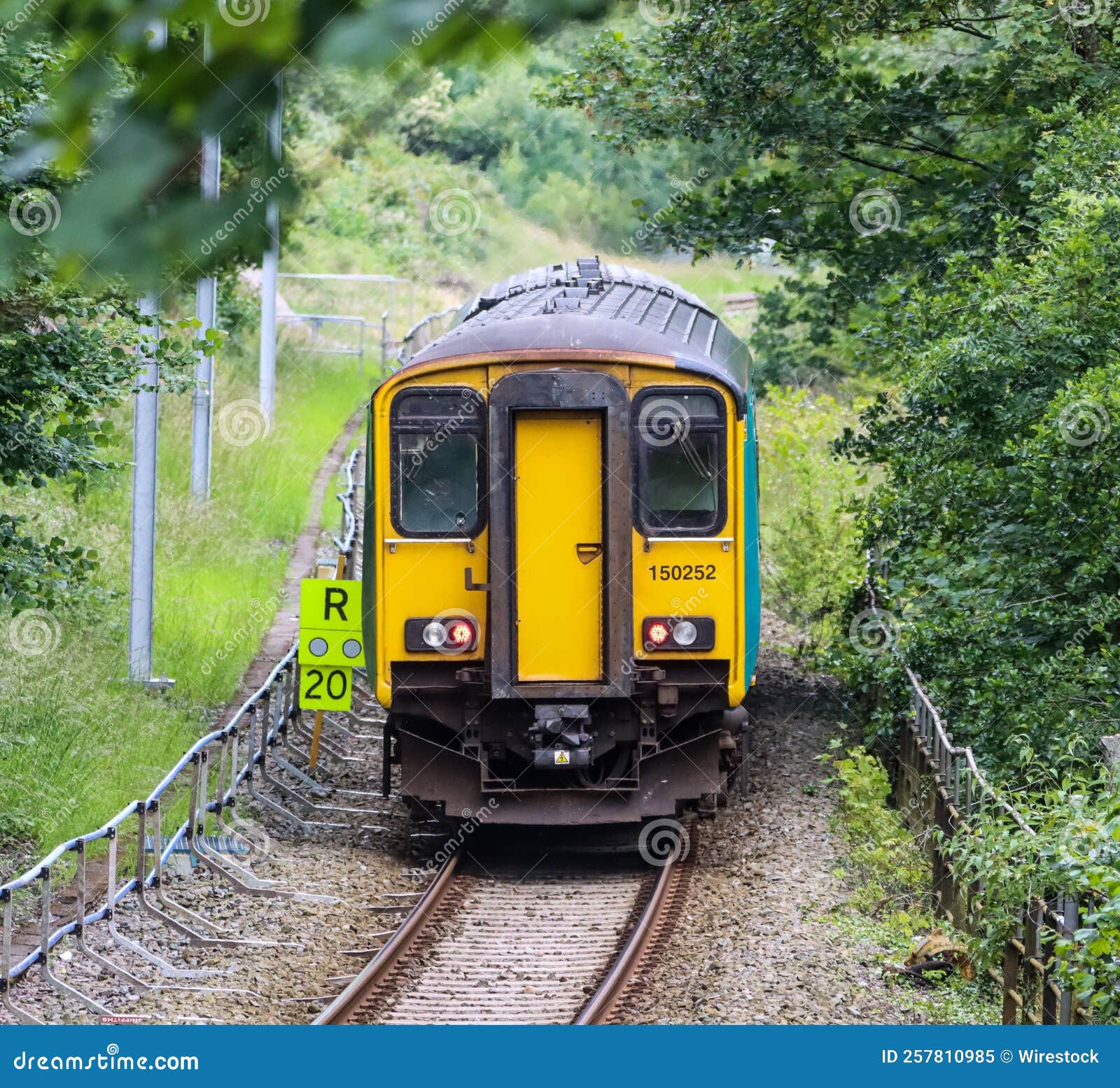 High-angle View of an Old Yellow Train Over the Rails Passing through ...