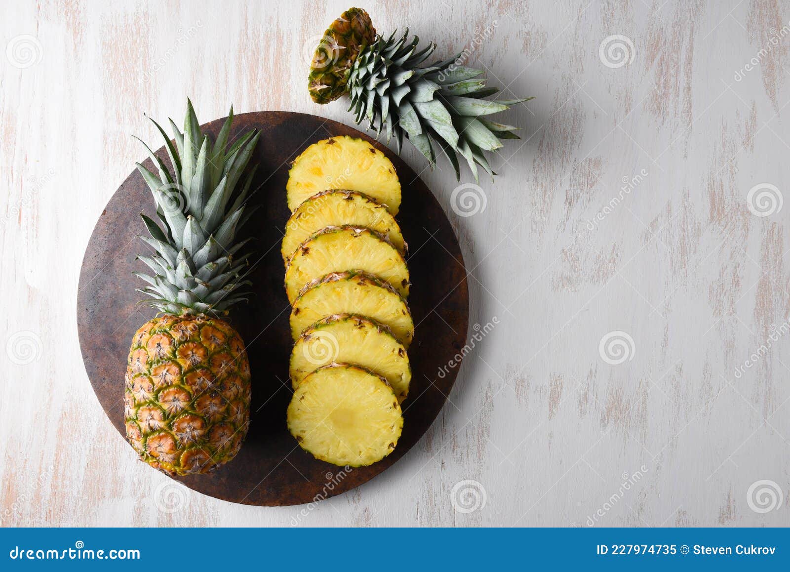 High Angle View of a One Cut Pineapple and a Whole Pineapple. on a ...