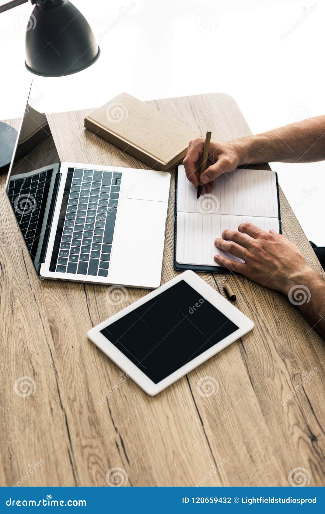 High Angle View of Person Taking Notes and Working with Laptop and ...