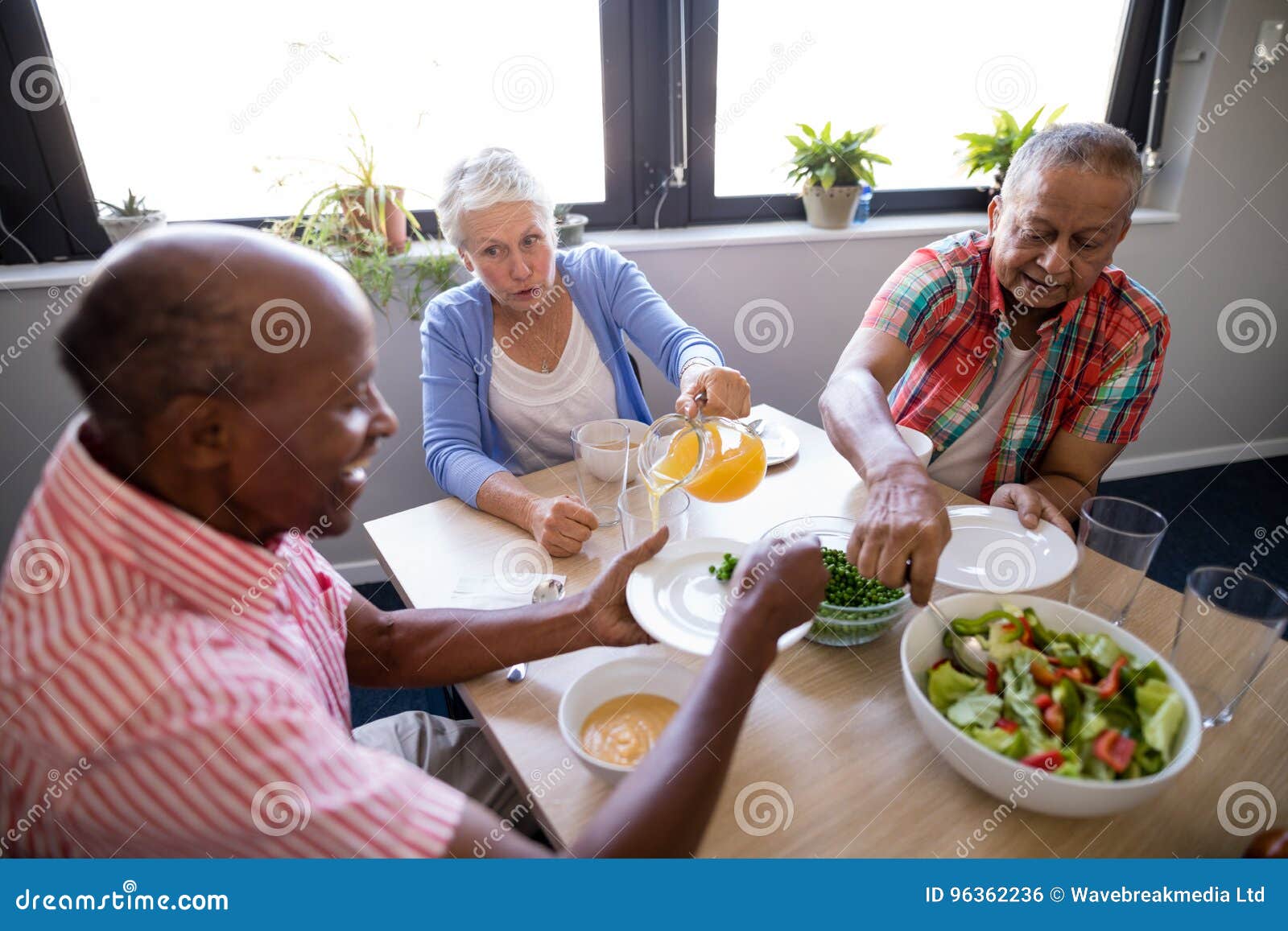 High Angle View of Senior People Having Salad and Juice Stock Photo ...