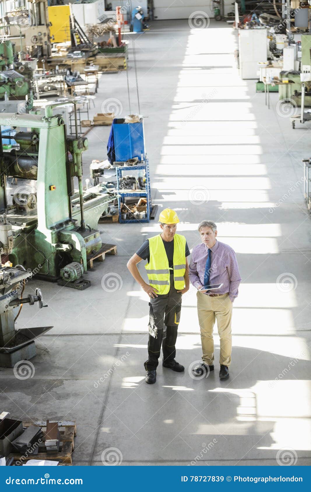 High Angle View of Supervisor and Manual Worker Having Discussion in ...