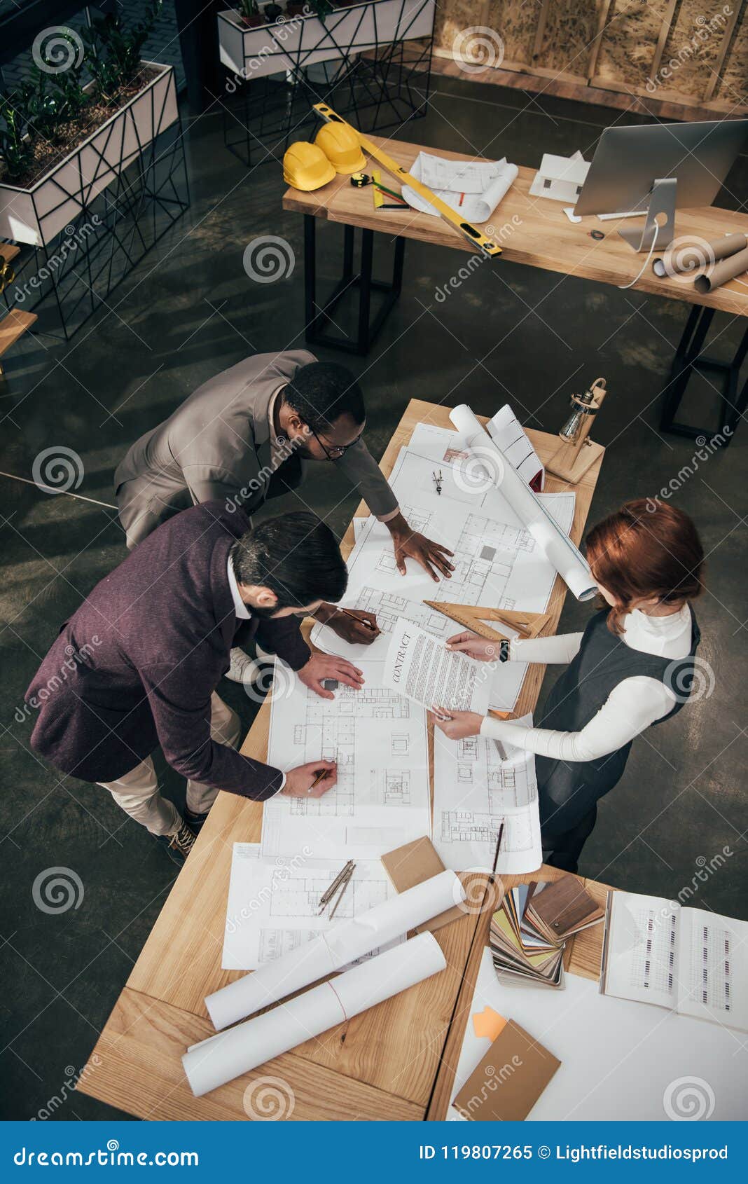 High Angle View of Team of Architects Working with Architectural Plans ...