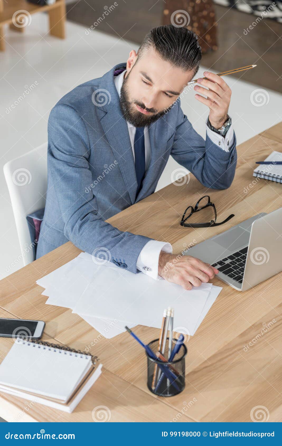 Thoughtful Businessman Working at Workplace with Laptop Stock Photo ...