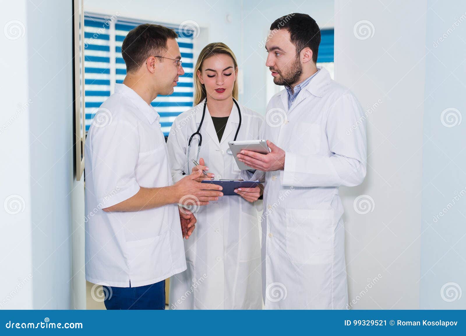 High Angle View of Three Doctors in White Coats Having Conversation at ...