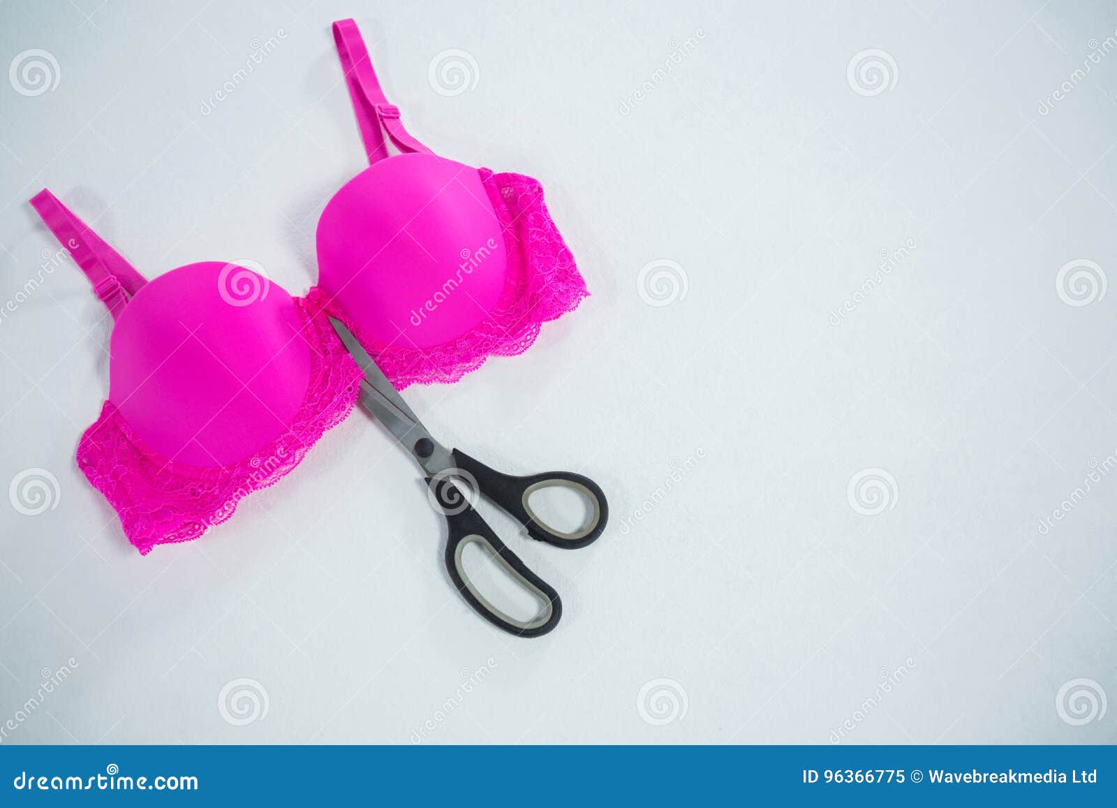 High Angle View of Vibrant Pink Bra with Scissors Stock Image - Image ...