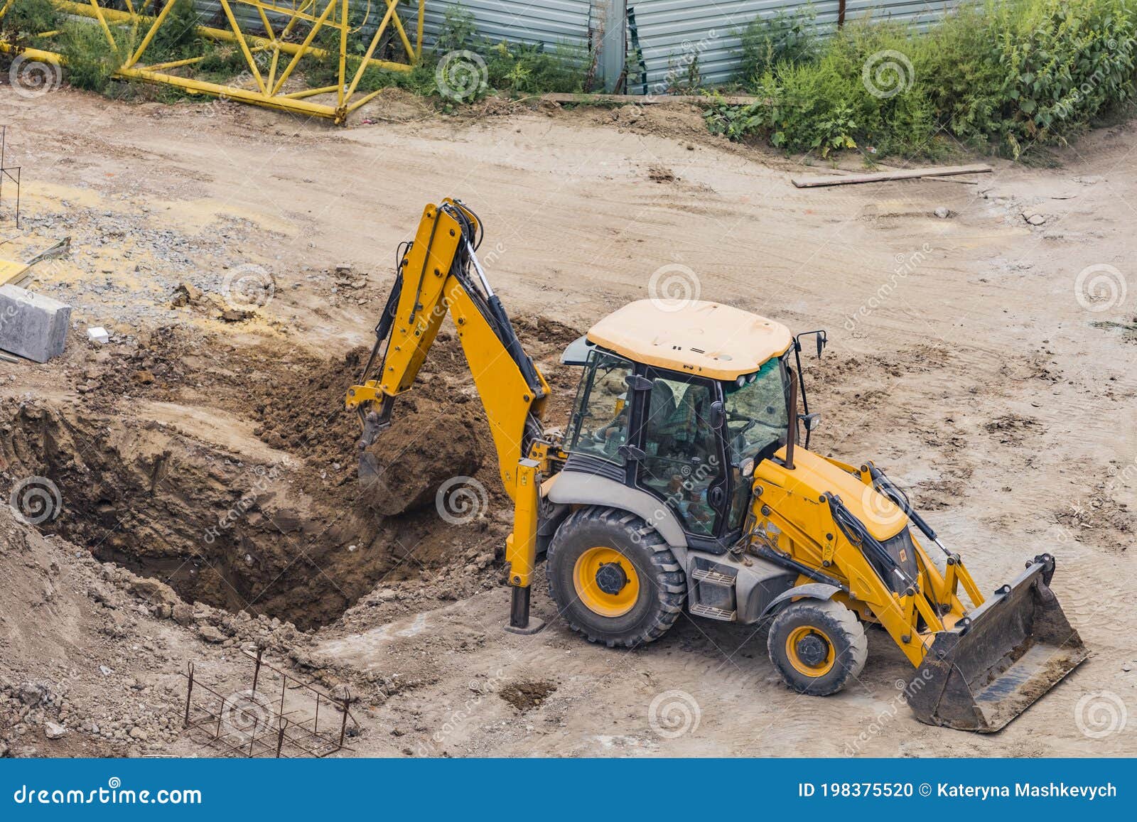 High Angle View of Yellow Mini Excavator on Construction Site Digging a ...