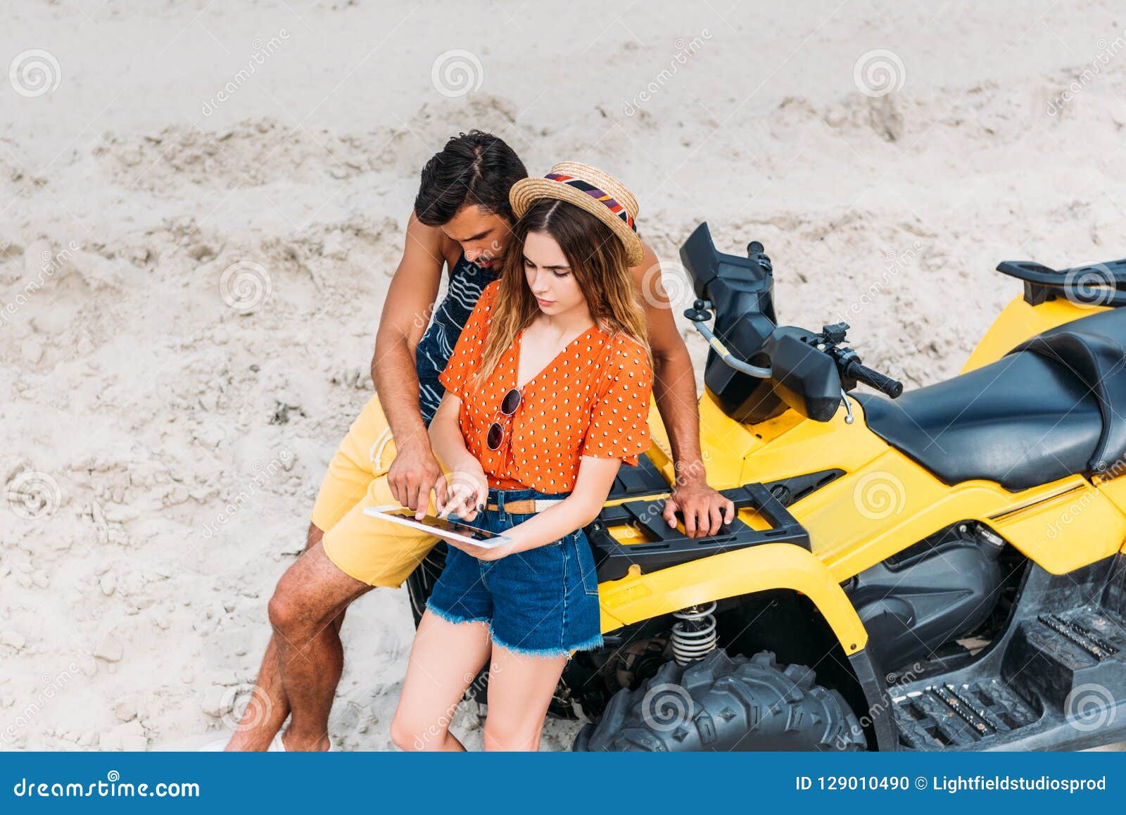 High Angle View of Young Couple with ATV Using Digital Tablet Stock ...
