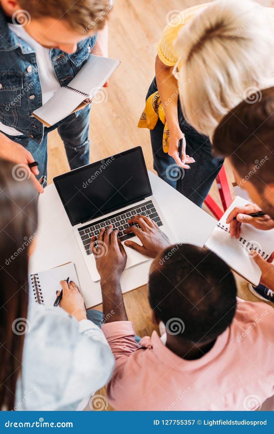 High Angle View of Young Students Using Laptop Together Stock Image ...