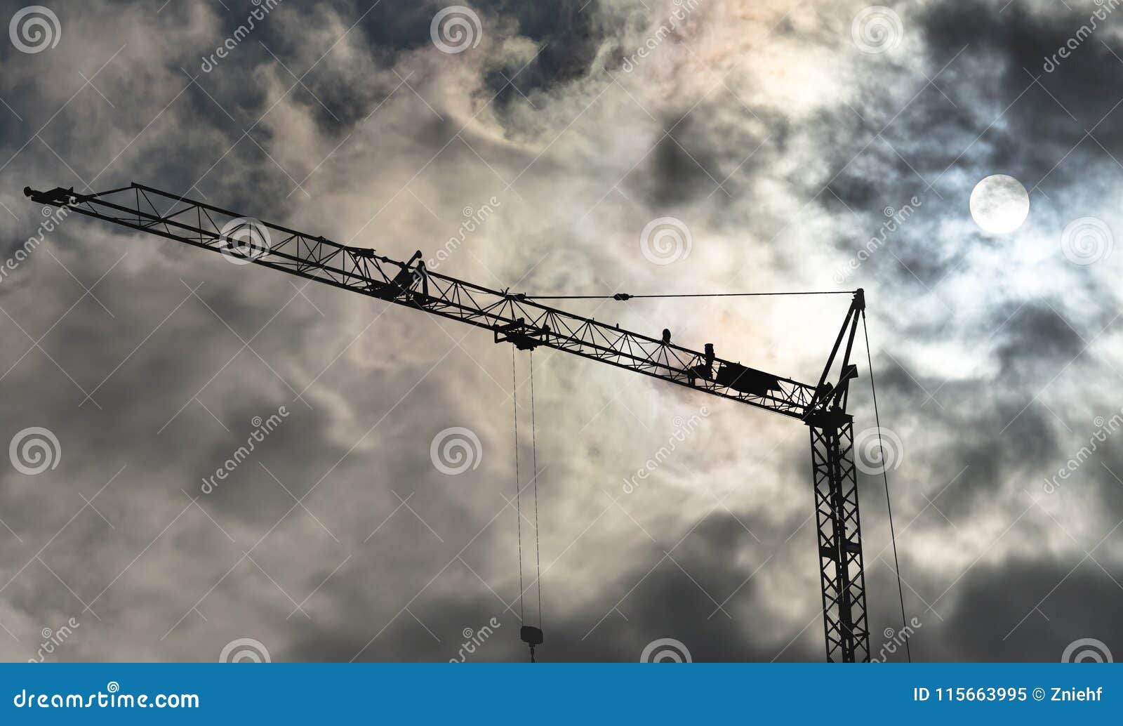 High Black Construction Crane in Front of a Dramatic Threatening Sky ...