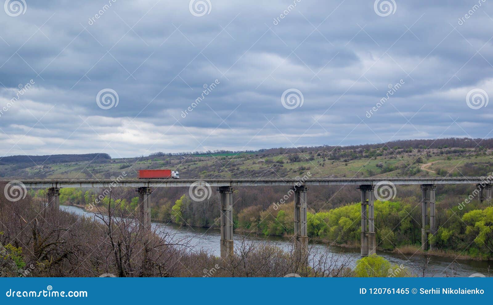 High Bridge Over the River. a Heavy Truck is Moving Along the Bridge ...