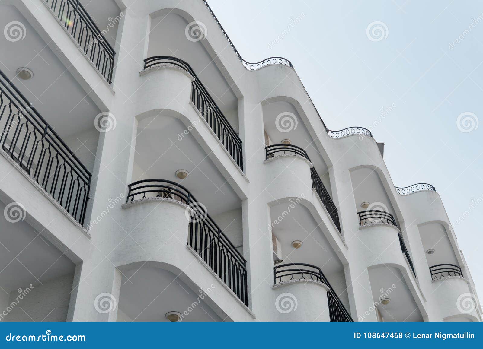 High Building with Balconies Against a Clear Sky Background Stock Photo ...