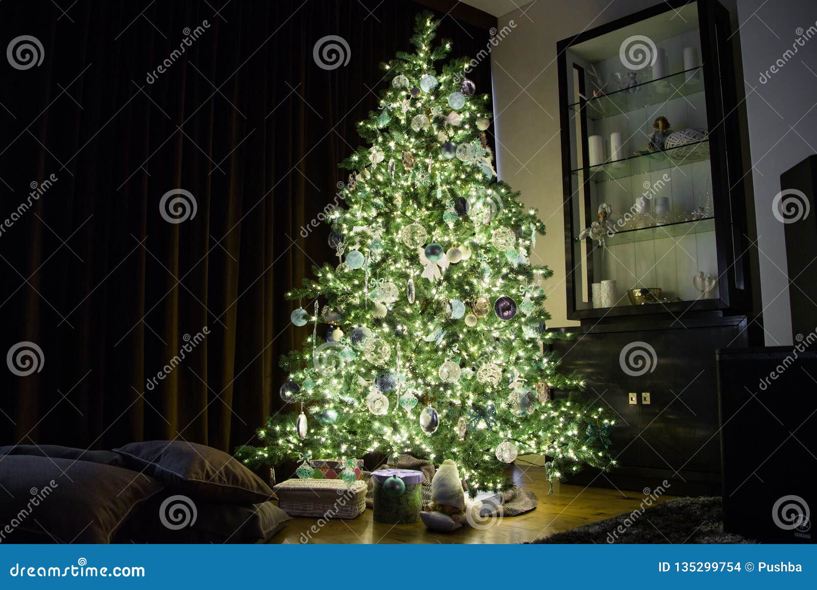 High Christmas Tree with Ornaments and Garlands Stock Photo - Image of ...