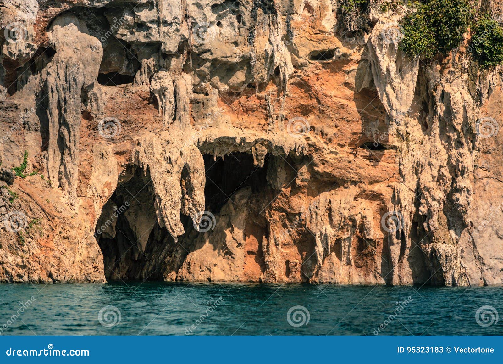 High Cliff with Cave and Water Underneath. Stock Image - Image of ...