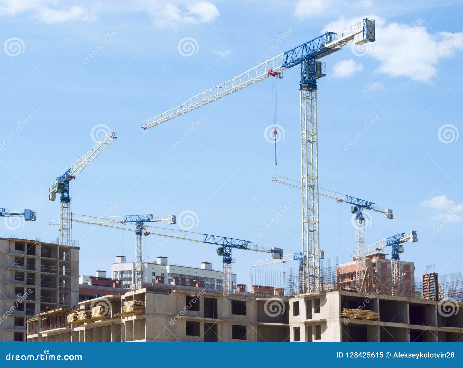 High Construction Cranes on a Construction Site Against a Blue S Stock ...