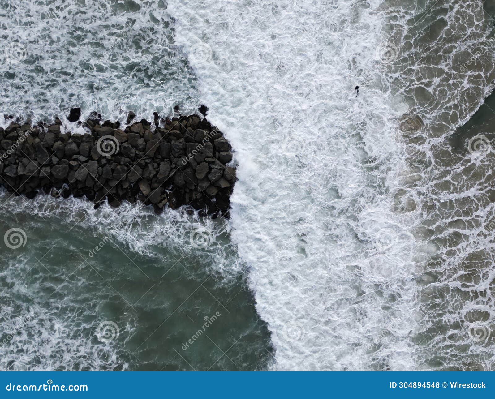 High-definition Aerial Photo of Waves Hitting Rocks on the Beach Stock ...