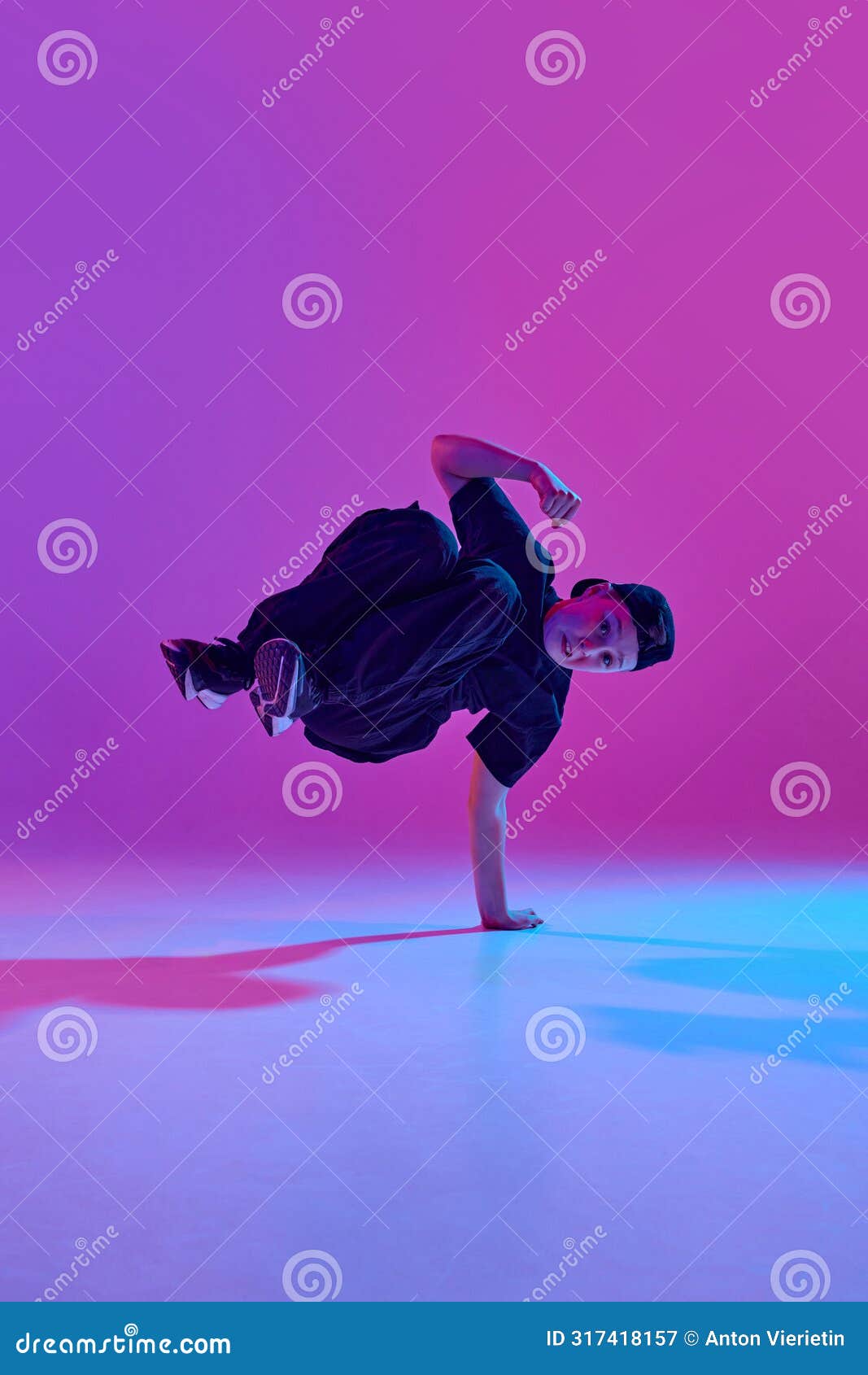 High-energy Dance. Young Boy Executing a Complex Dance Move in Mixed ...