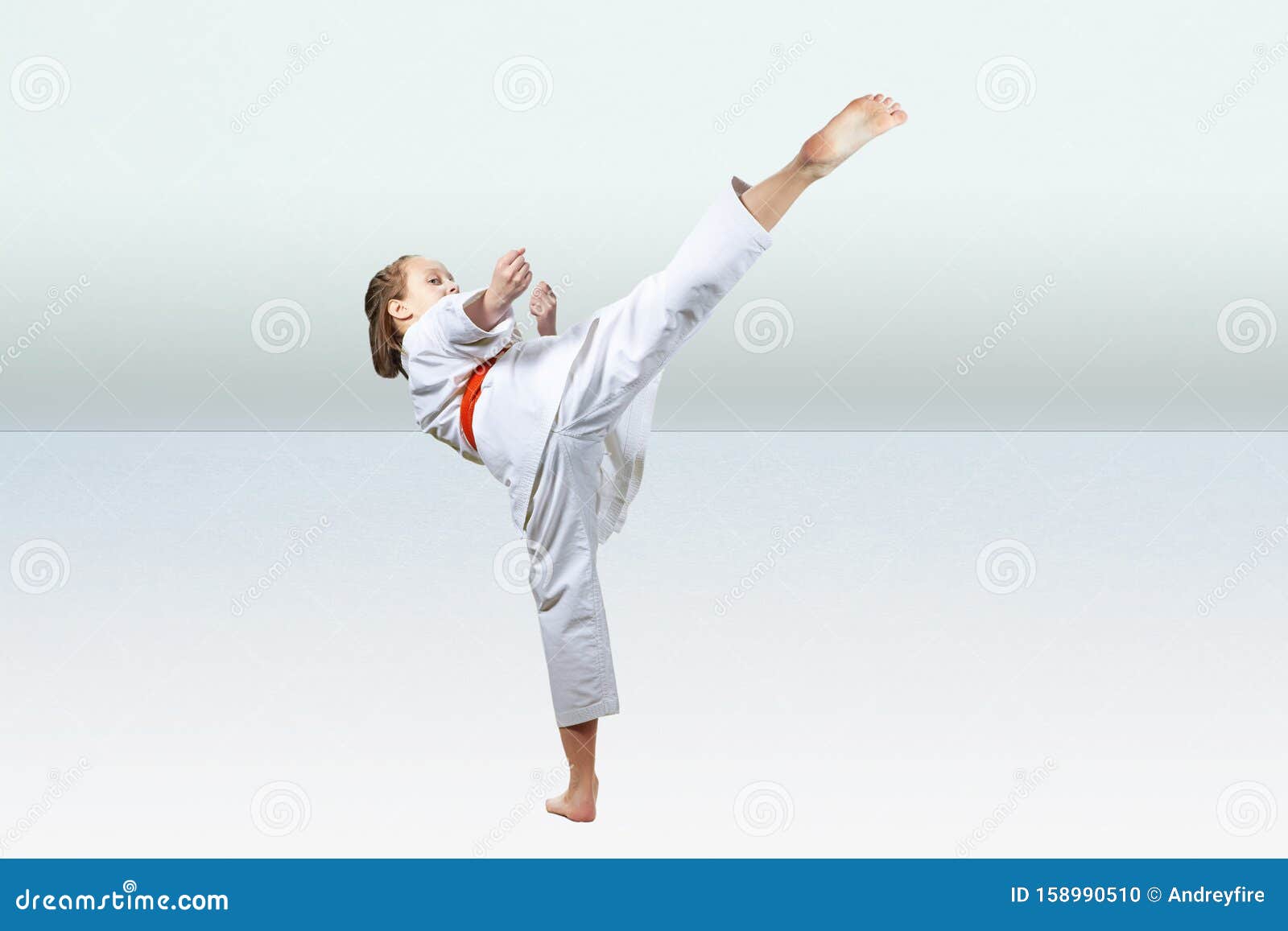High Kick Leg is Beating the Girl with a Red Belt Stock Photo - Image ...