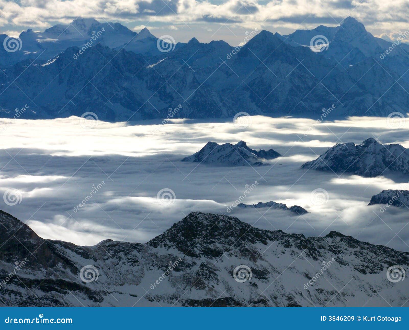 High Mountains between Cloud Layers Stock Image - Image of clouds, snow ...