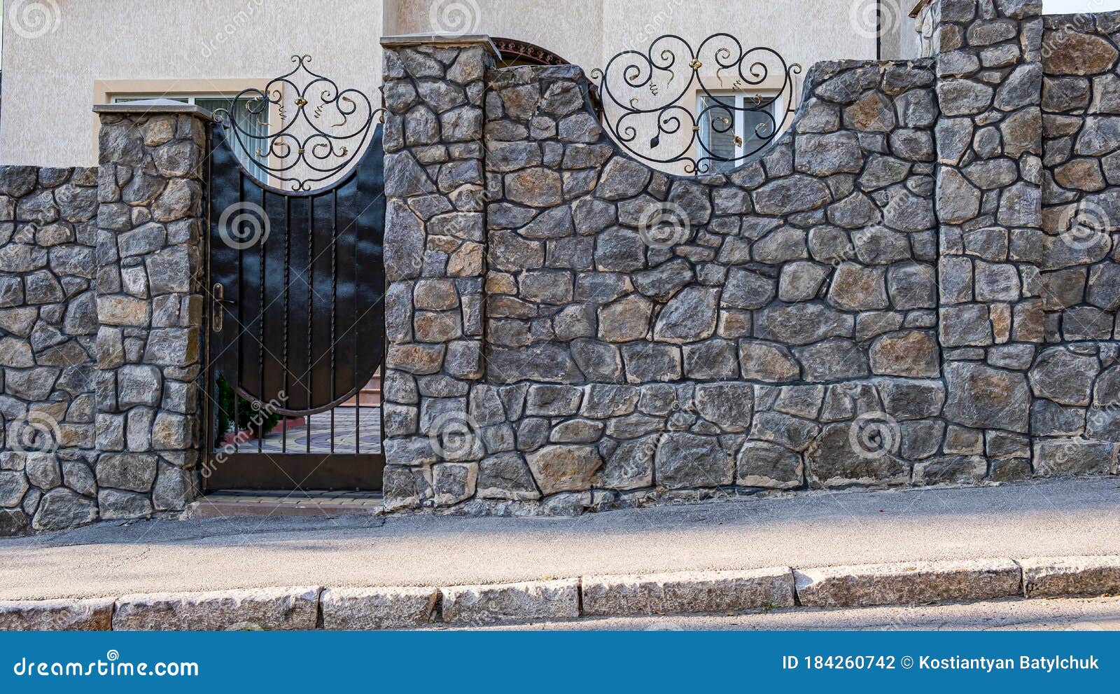 High Powerful Stone Fence with a Gate Stock Photo - Image of home ...