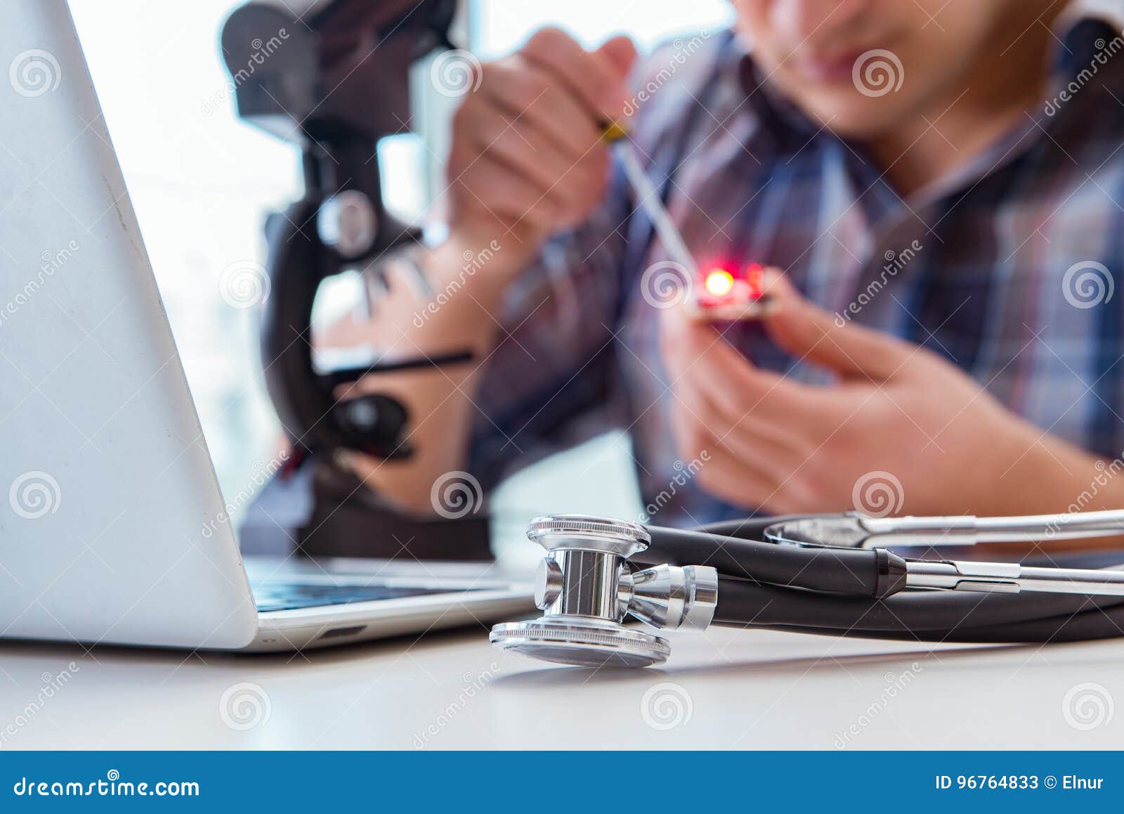 The High Precision Engineering with Man Working with Microscope Stock ...