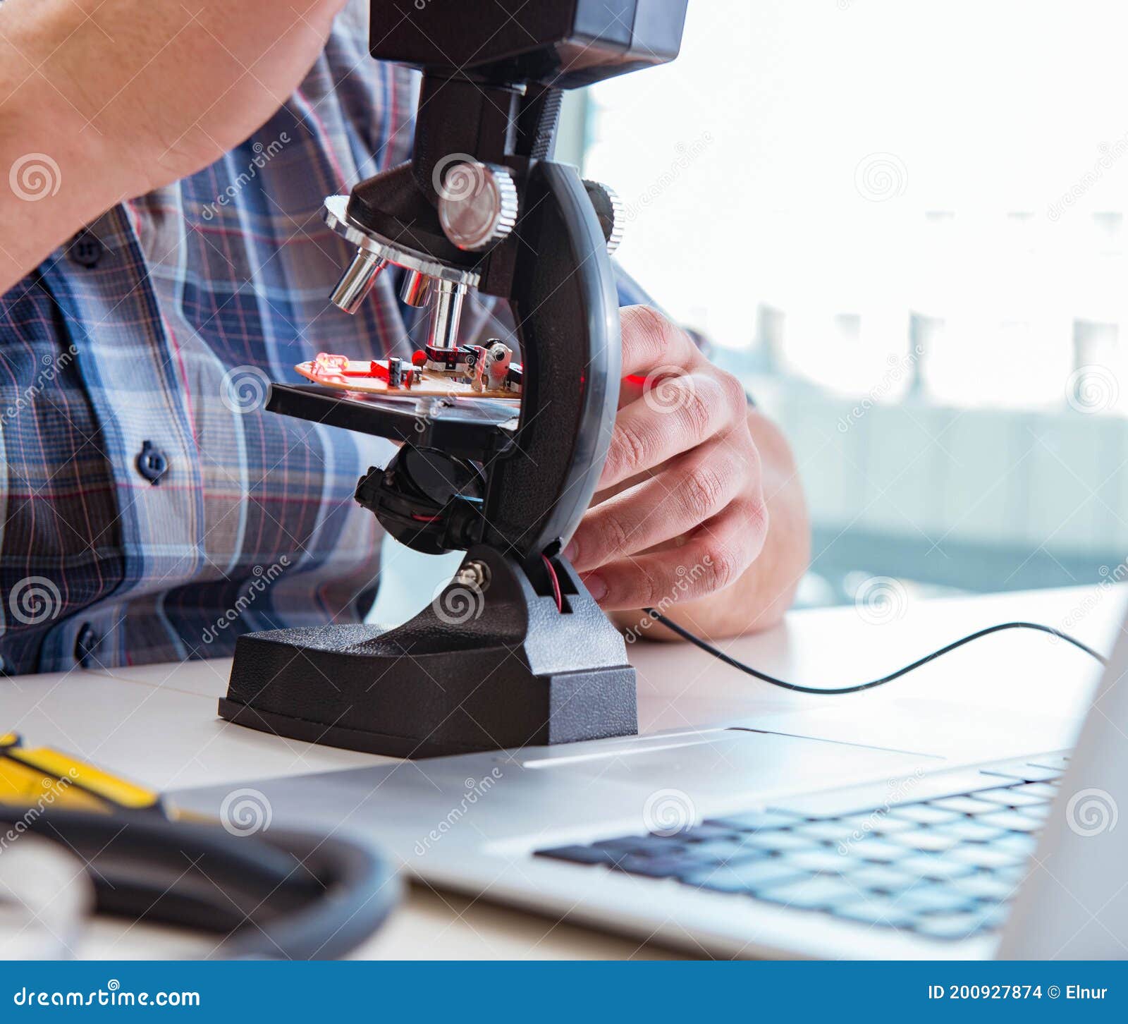 High Precision Engineering with Man Working with Microscope Stock Photo ...