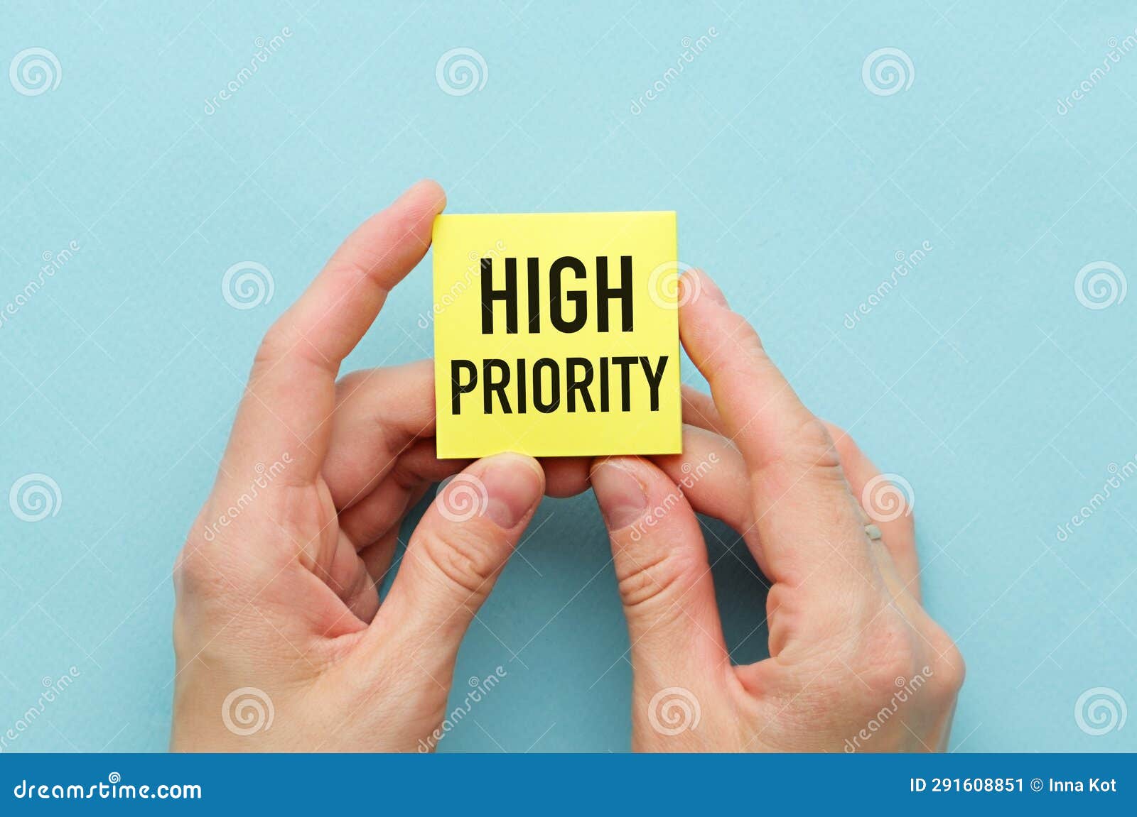 High Priority Text Written on Sticky in Hands on Blue Background Stock ...