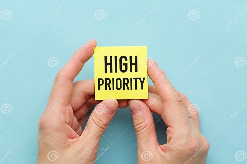 High Priority Text Written on Sticky in Hands on Blue Background Stock ...